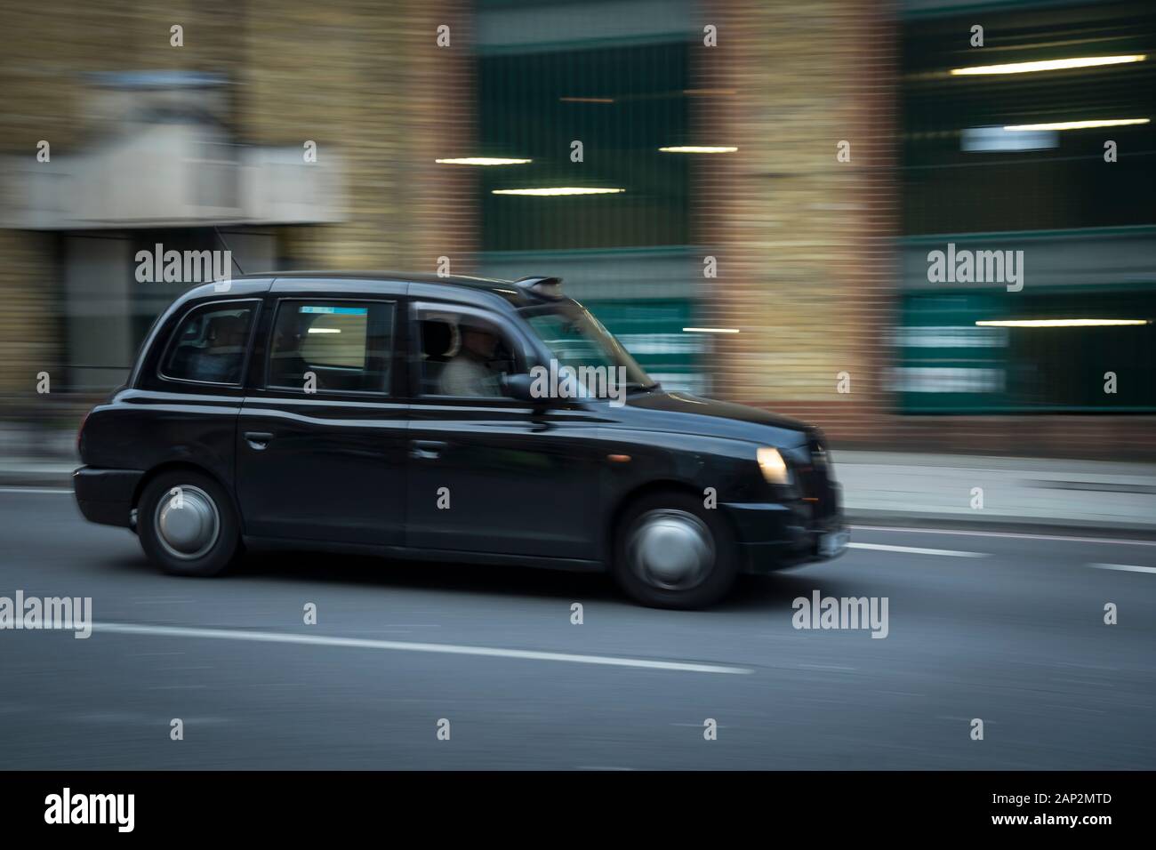 Moving taxi in the streets of London Stock Photo - Alamy