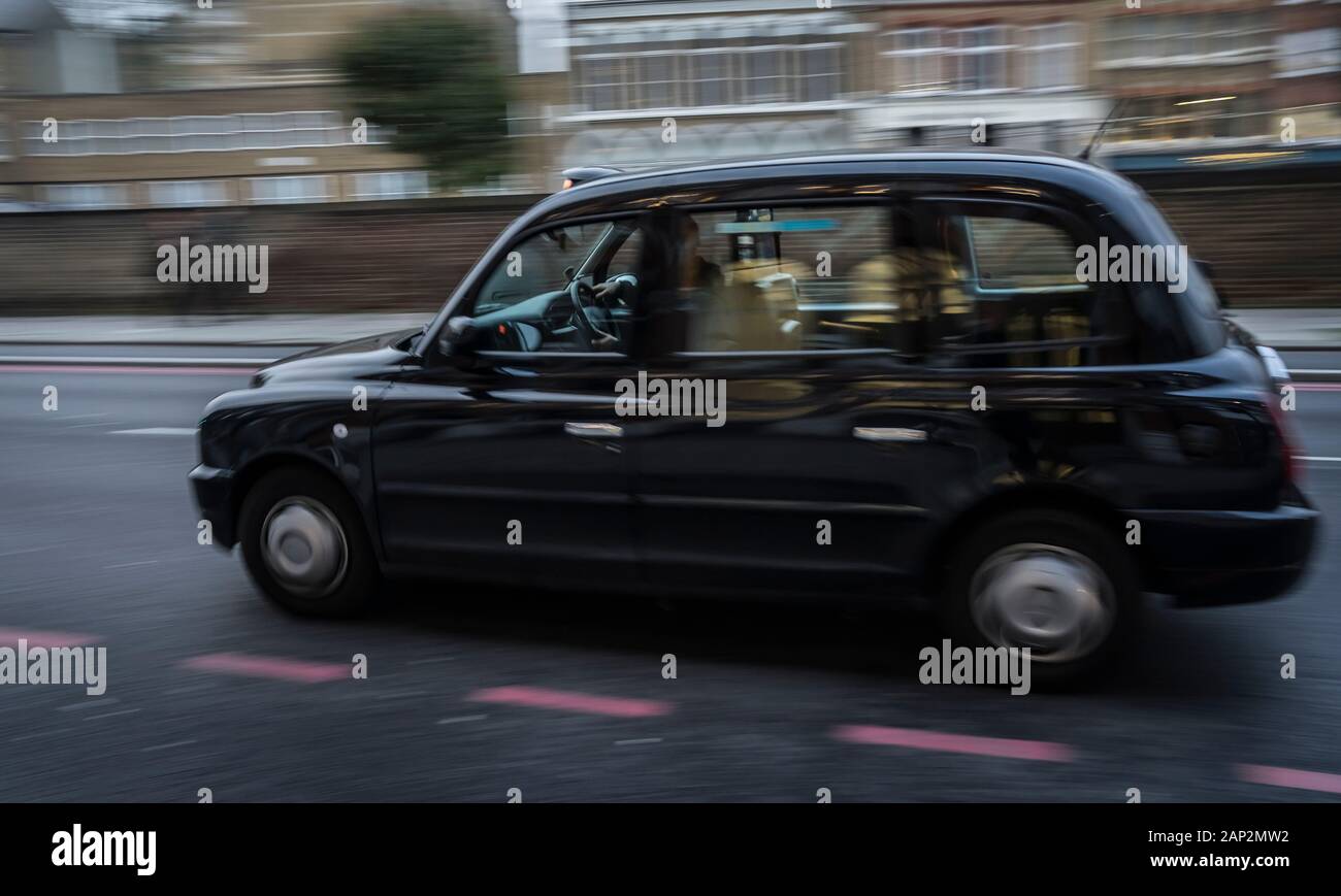 Moving taxi in the streets of London Stock Photo - Alamy