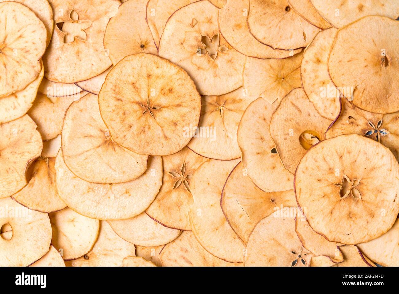 Flat lay Dried apple chips textured background Stock Photo - Alamy