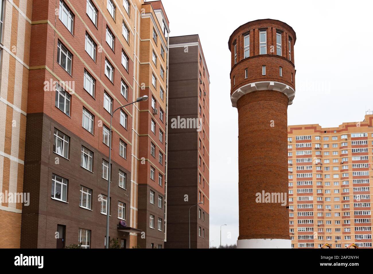 Water tower. Historical heritage in the city. Old buildings among high ...