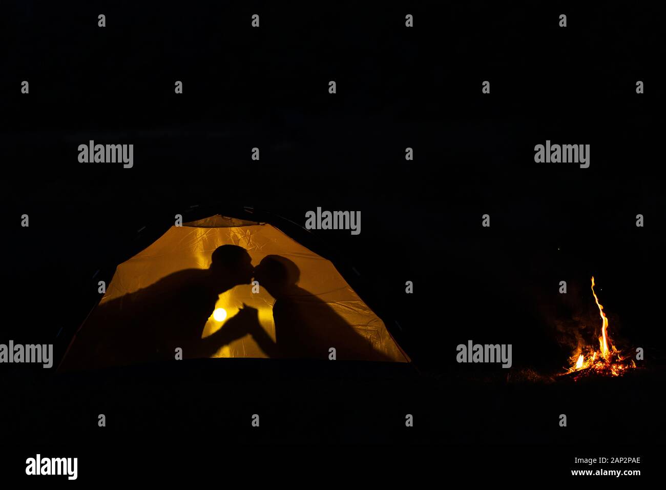 Shadow of a couple in love kisses in a tourist tent in nature. camping ...