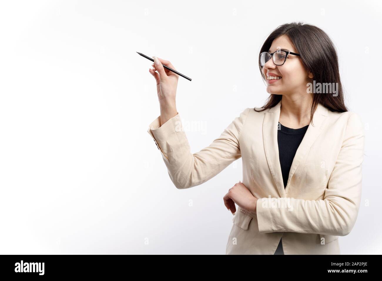 Cheerful enthusiastic businesswoman writing something with a pencil in ...
