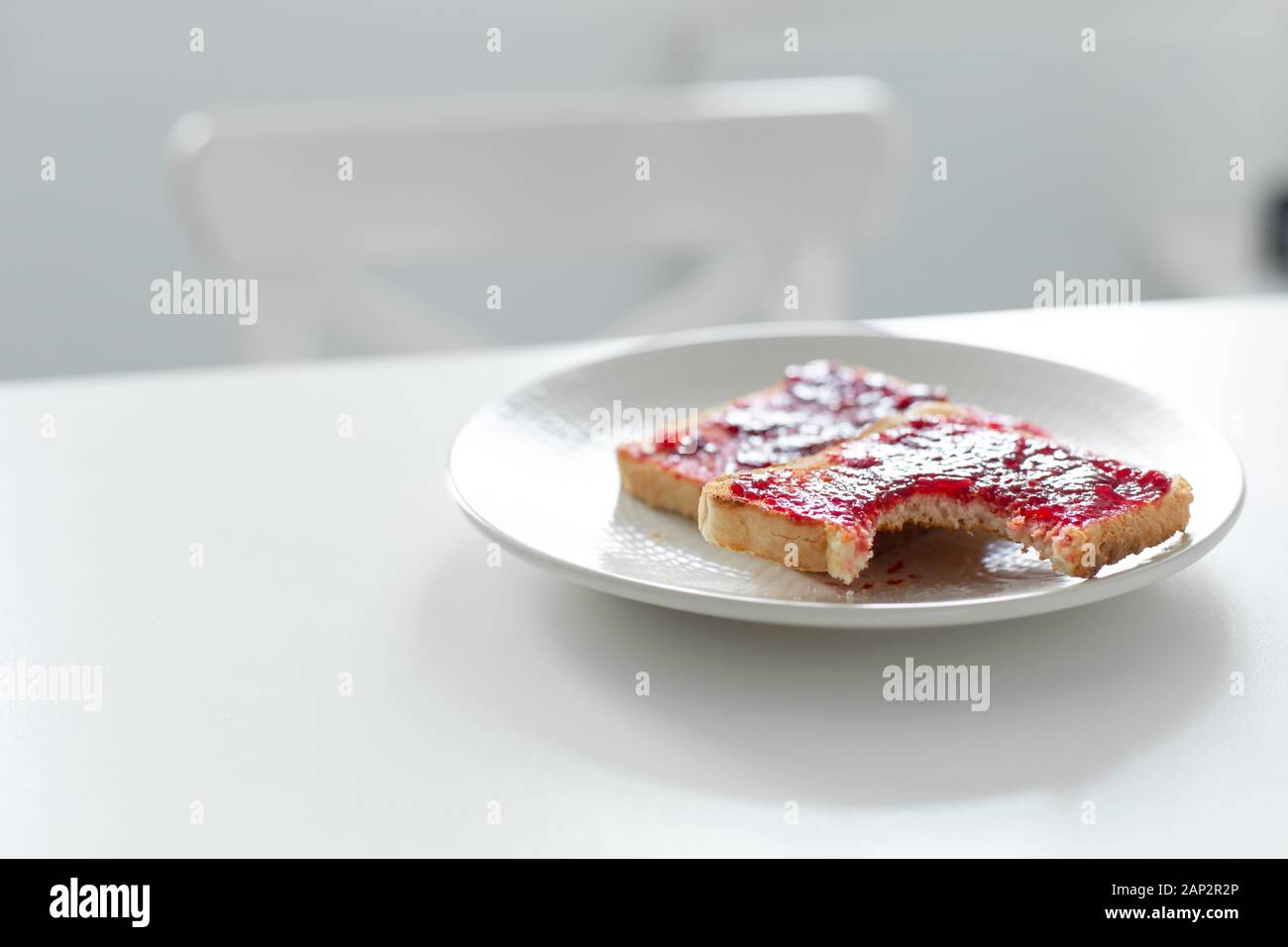 Bitten toast with jam on the table. Late for work did not have time to ...