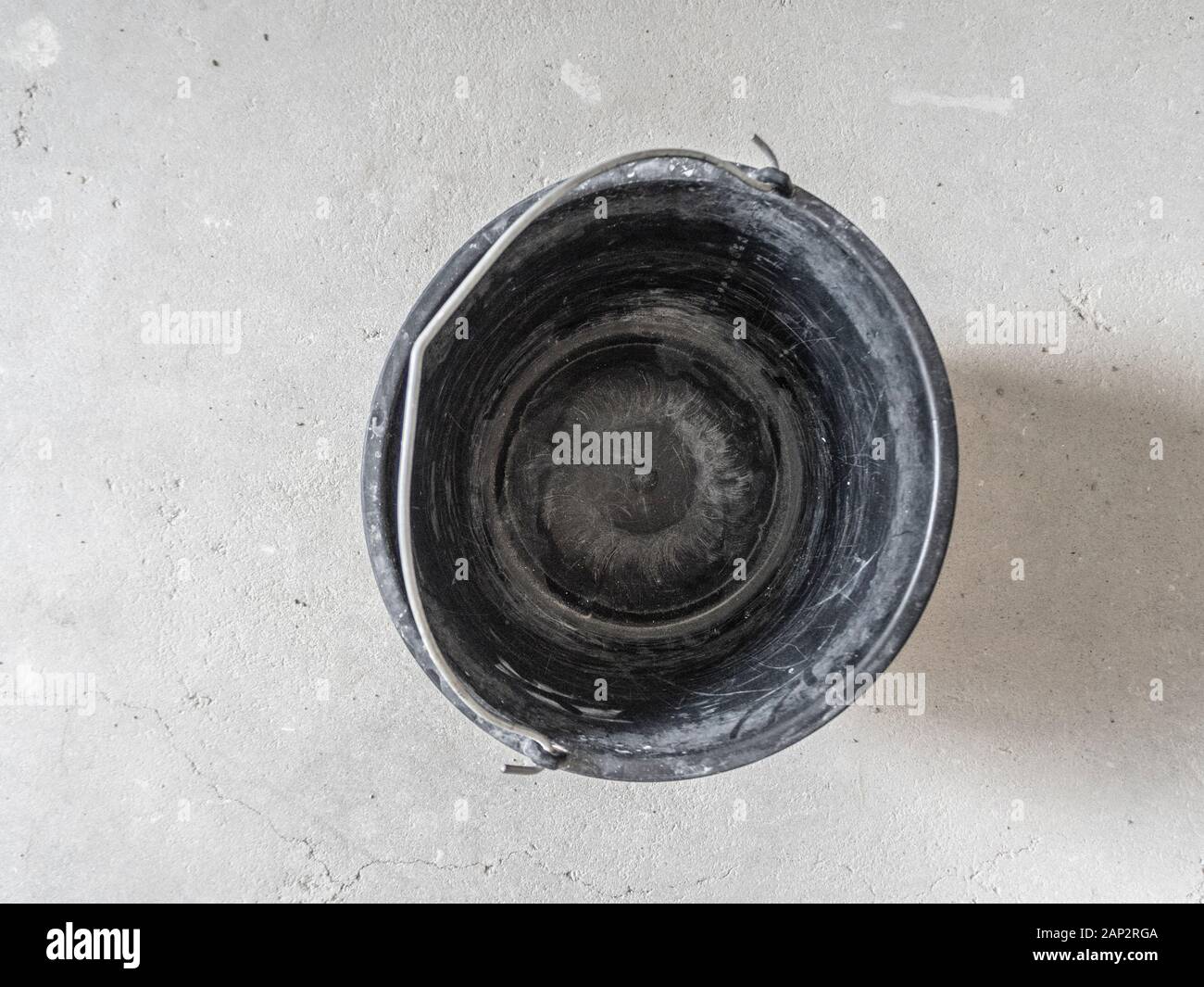 Black plastic bucket in an empty room Stock Photo - Alamy