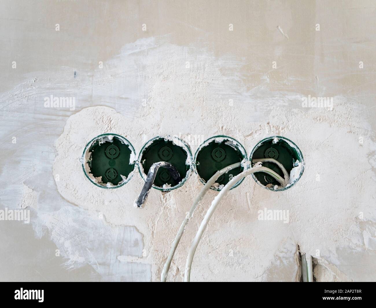 Hole in the wall under the socket Stock Photo - Alamy