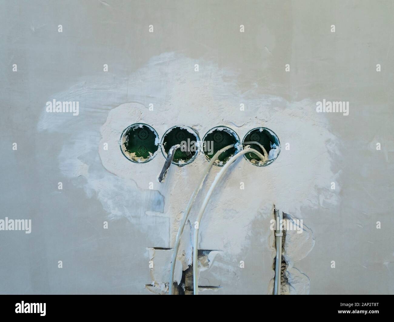 Hole in the wall under the socket Stock Photo - Alamy