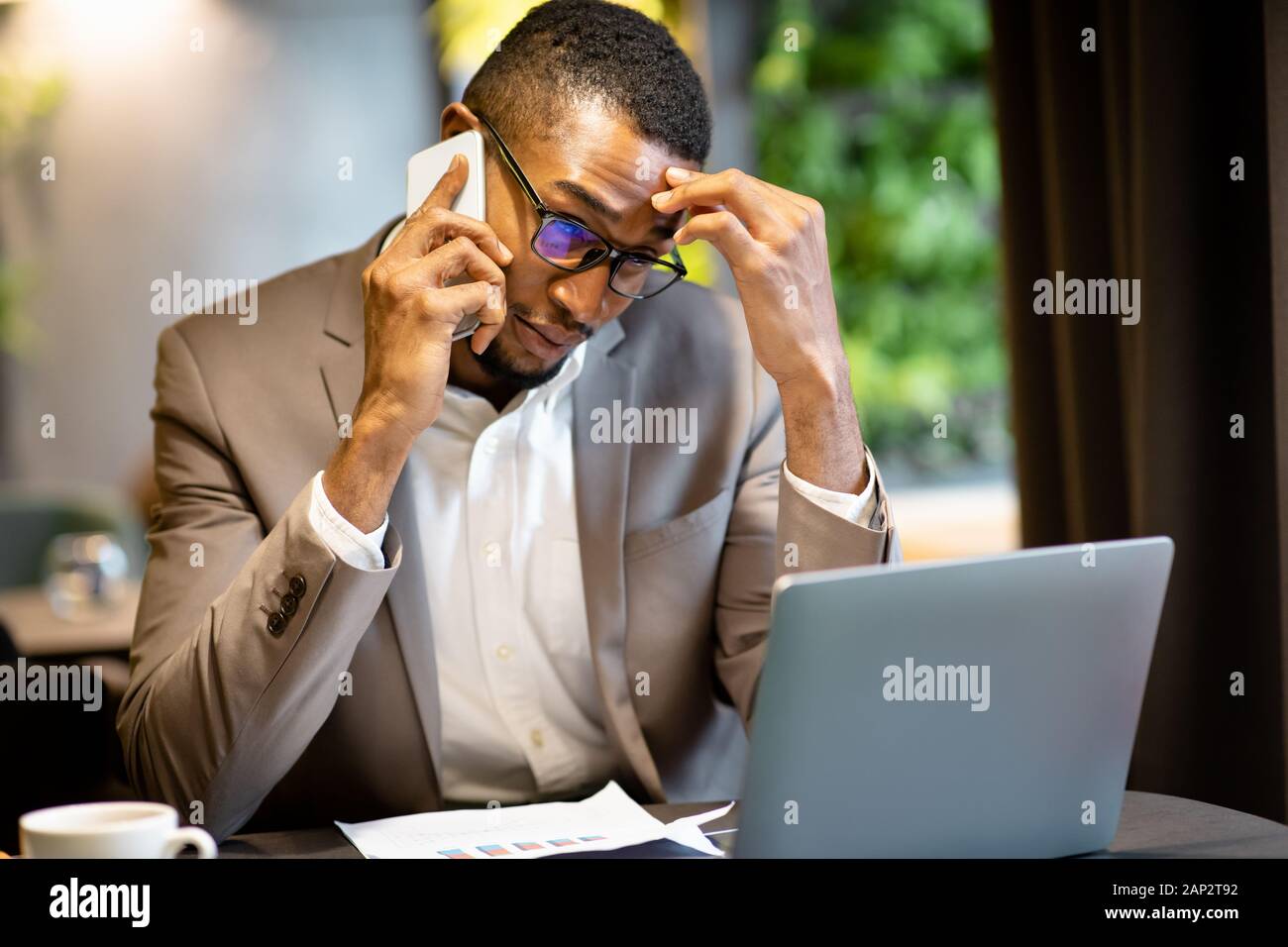Portrait of focused afro businessman making phone call Stock Photo - Alamy