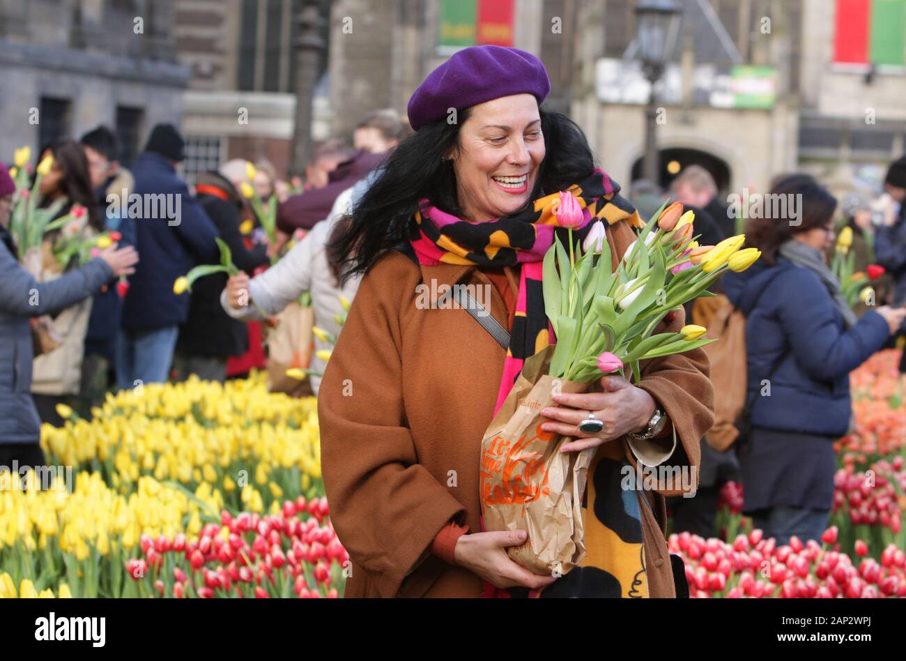 People attend National Tulip Day in front of the Royal Palace at the ...