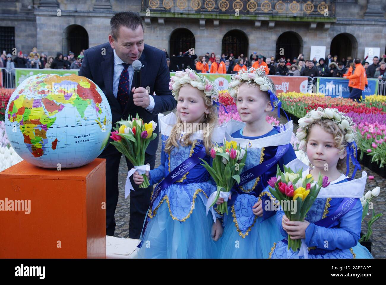 People attend National Tulip Day in front of the Royal Palace at the ...