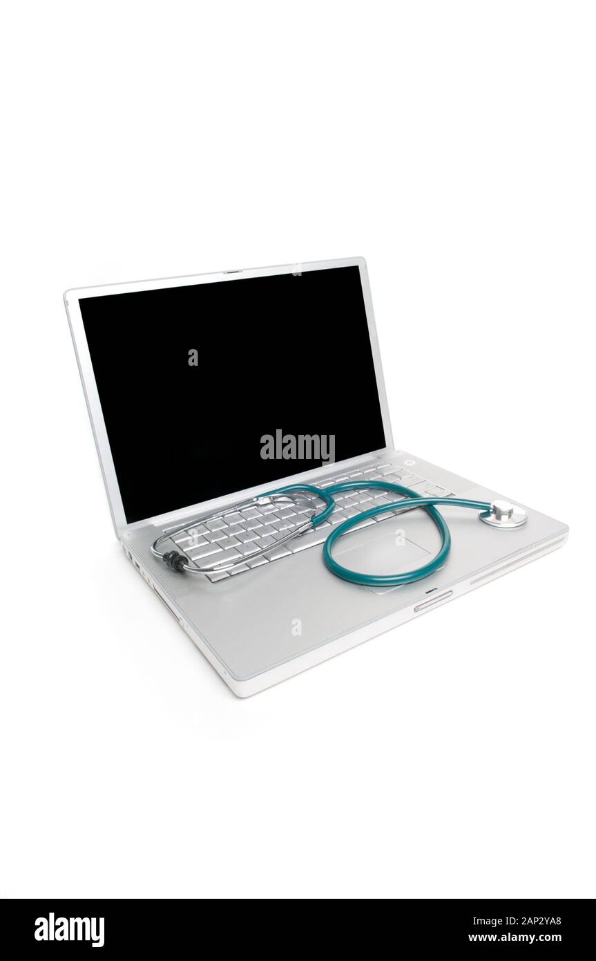 Laptop computer standing with blank screen open and stethoscope lying ...