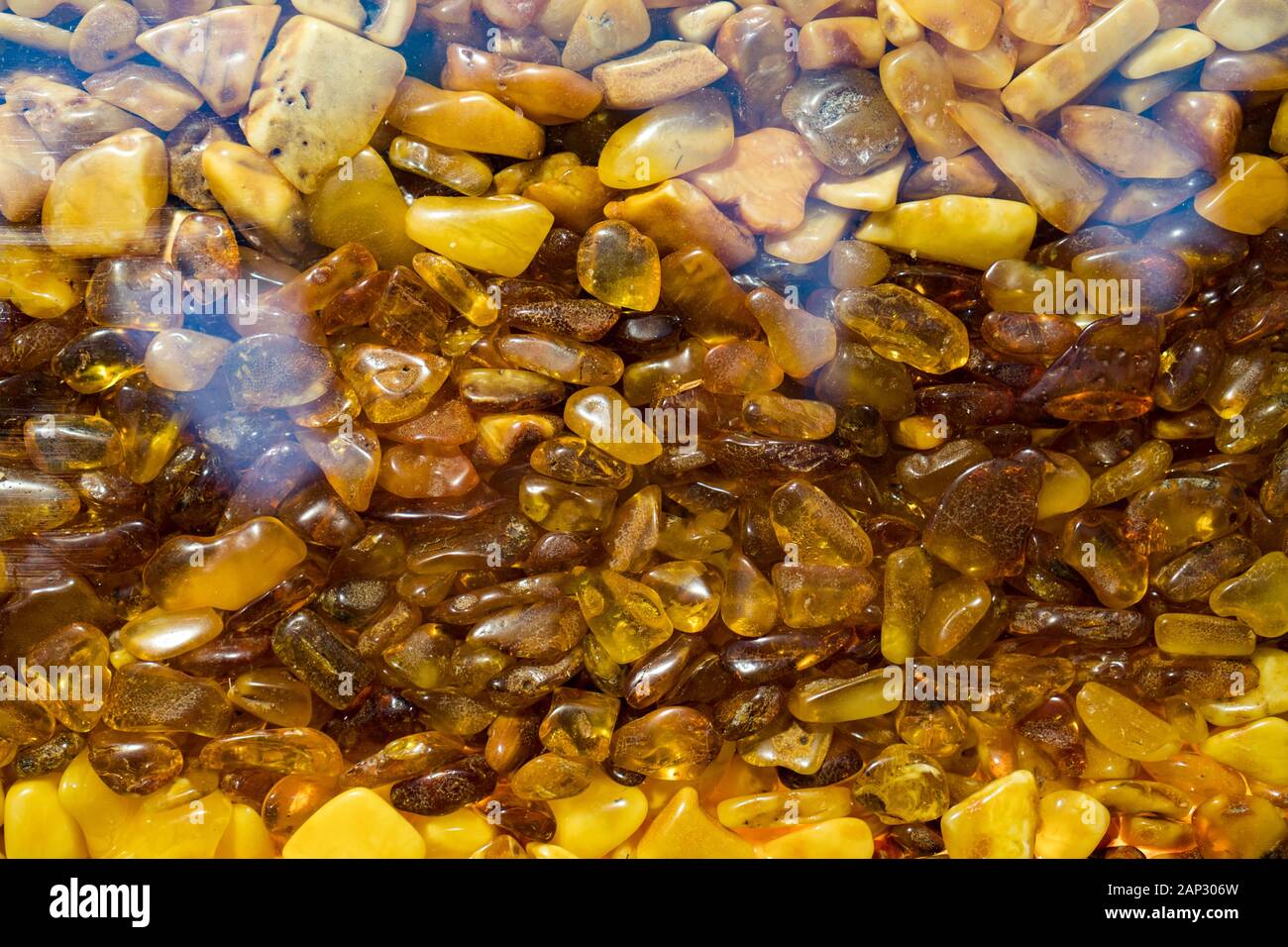 Amber grains with backlight illumination as texture or background. heap ...