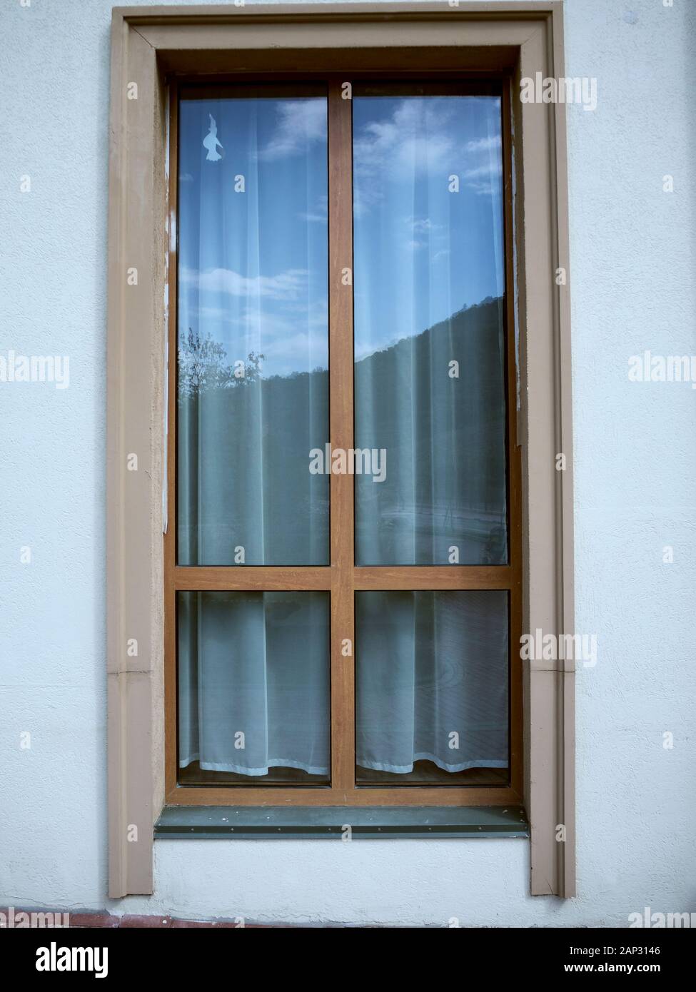 One large window on the wall of the house outside in the daytime in a ...