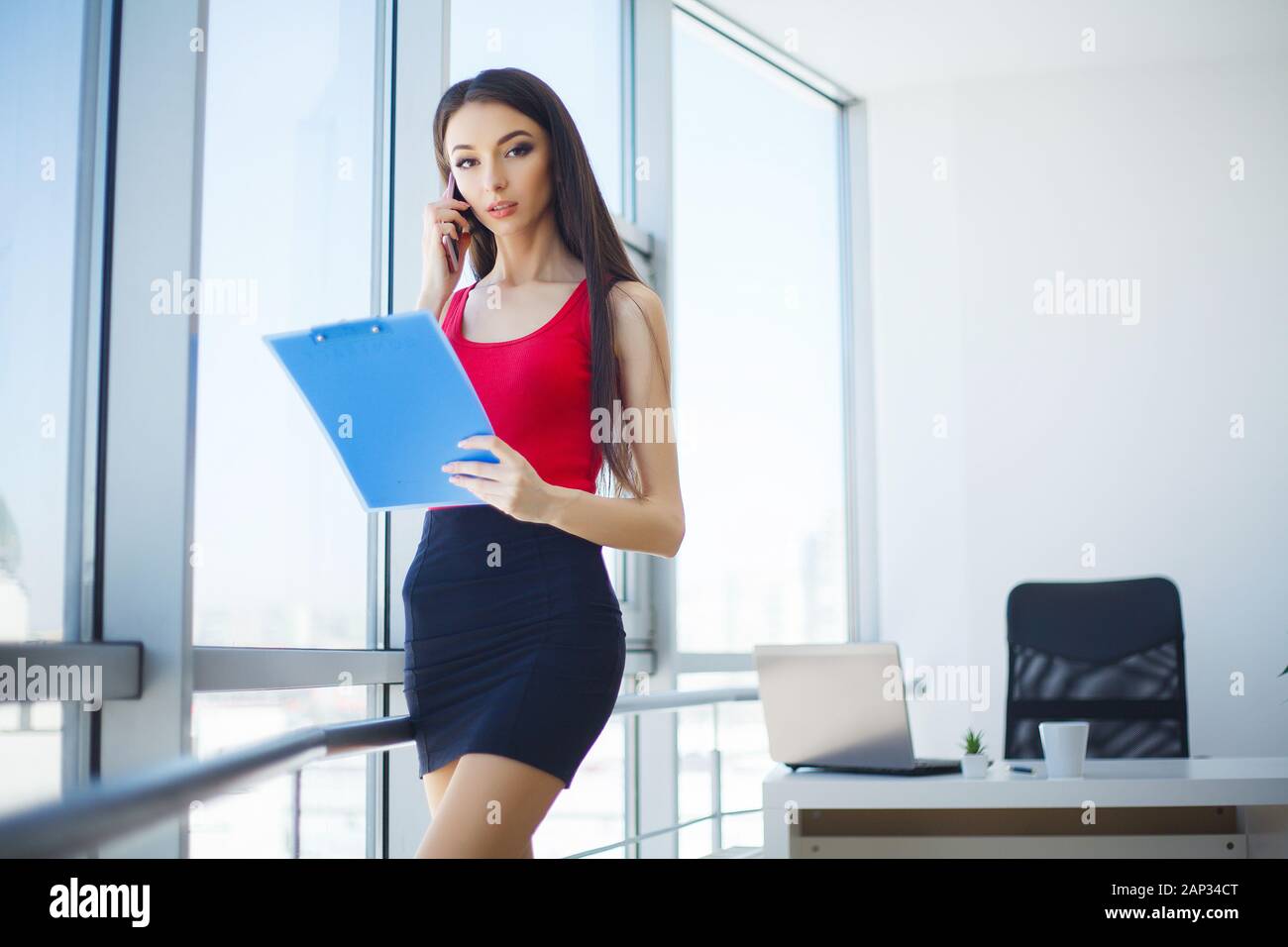 Young professional woman with her cellphone. Attractive young financial ...