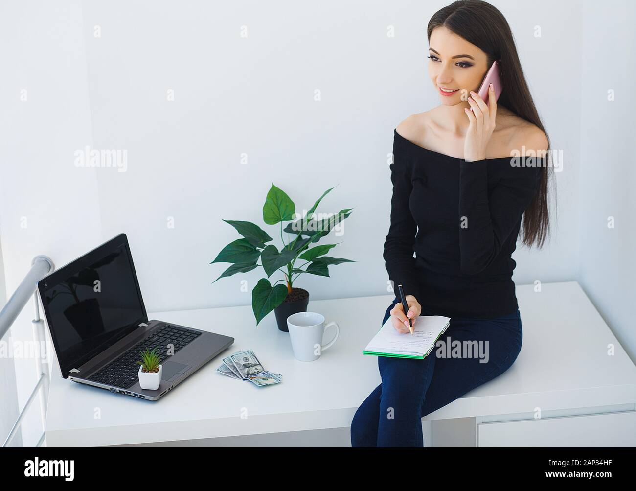 Beautiful young girl working on computer at home Stock Photo - Alamy