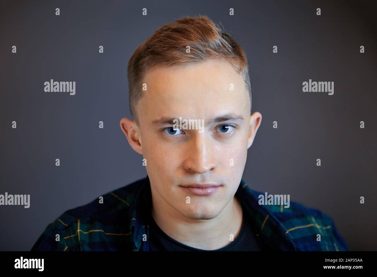 The face of a serious young man of Caucasian ethnicity, a little over ...