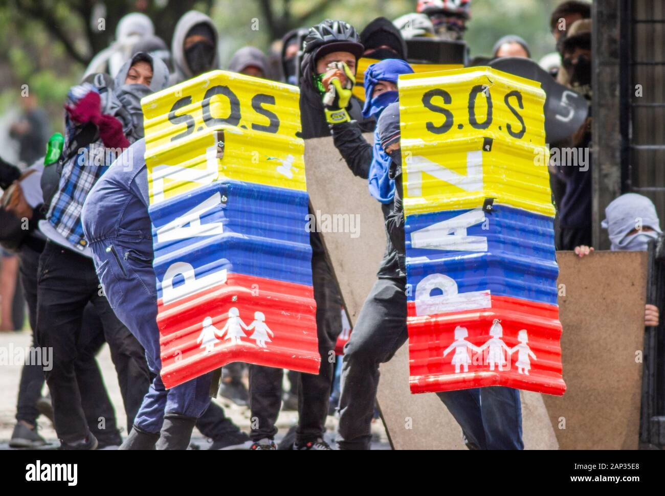 Hooded in riots in the Colombian national strike Stock Photo - Alamy