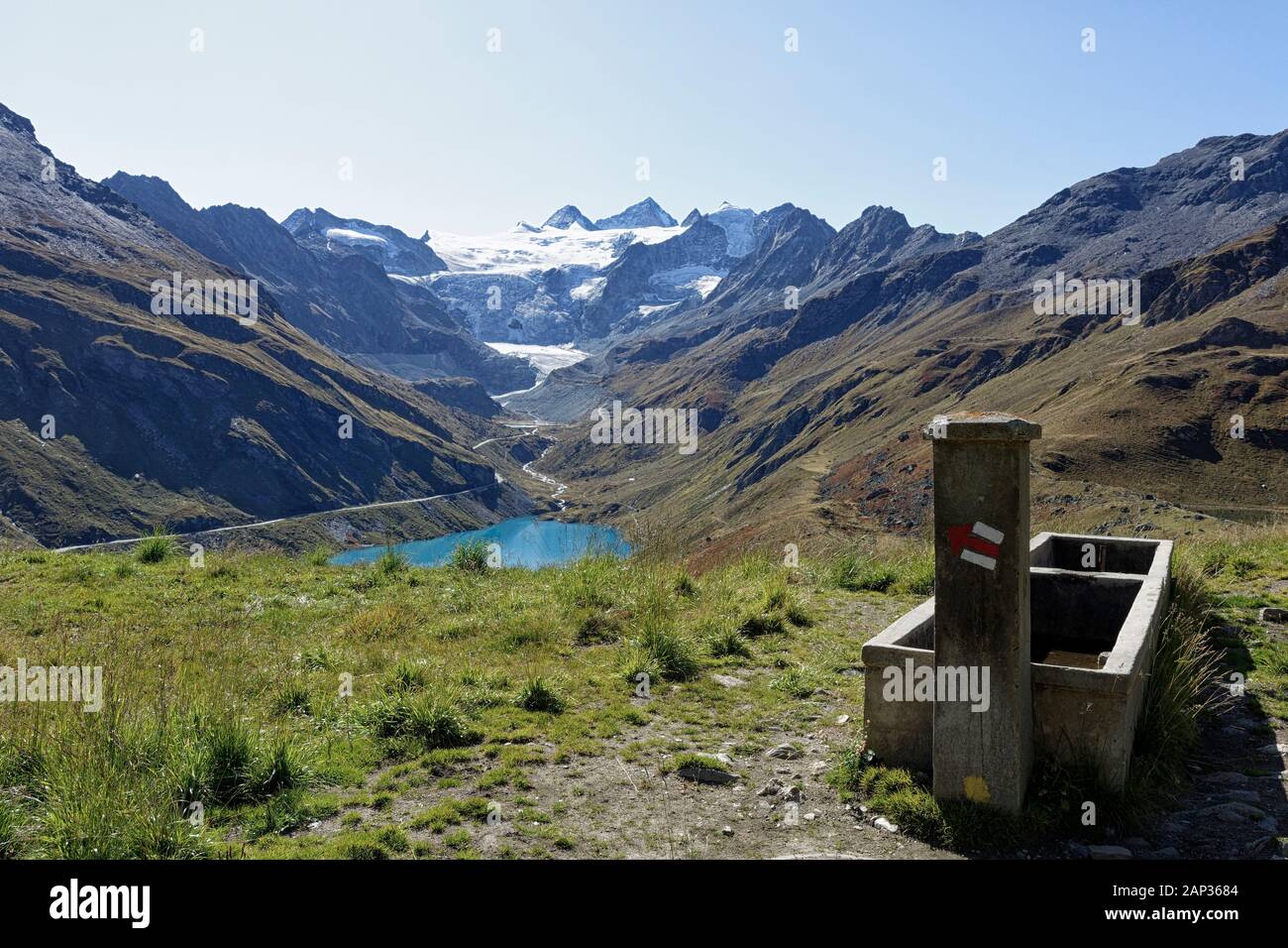 Fountain on the Alpage de Torrent with a view of the Lac de Moiry and ...