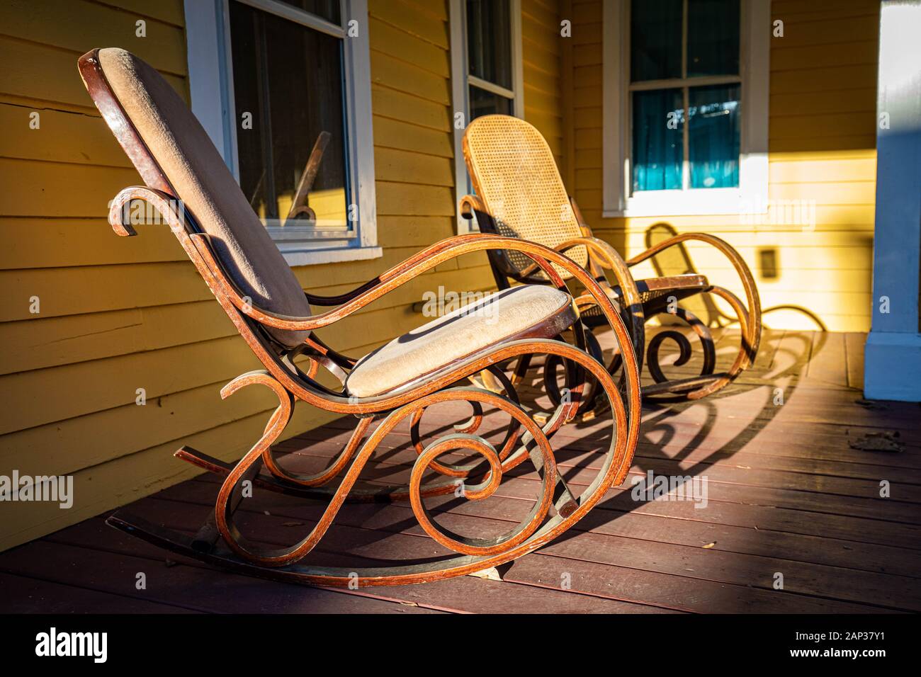 Wooden rocking chair on front porch at sunset nobody Stock Photo - Alamy