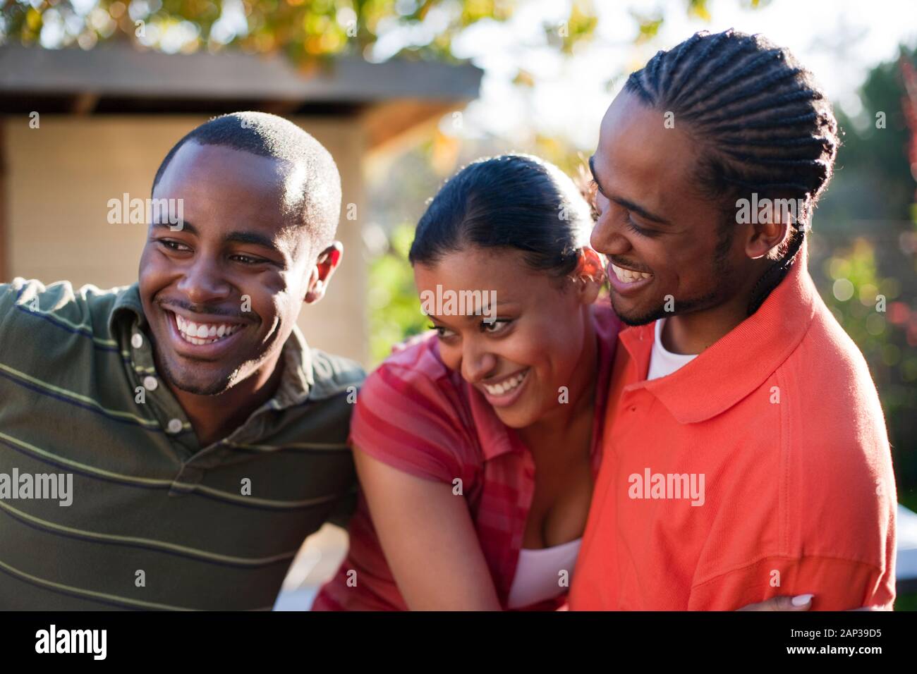 People smiling and embracing with arms around Stock Photo - Alamy