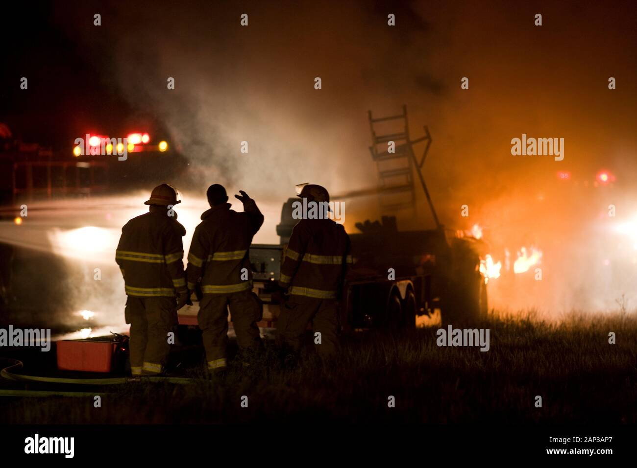 Firefighters at the scene of a fire Stock Photo - Alamy