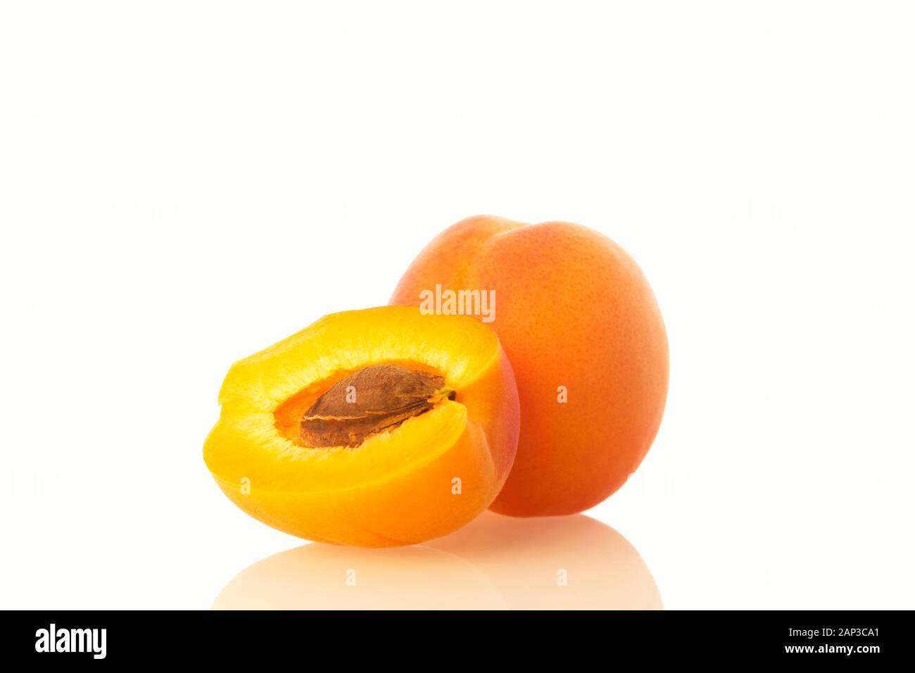 Whole and cutted apricots isolated on white background Stock Photo - Alamy