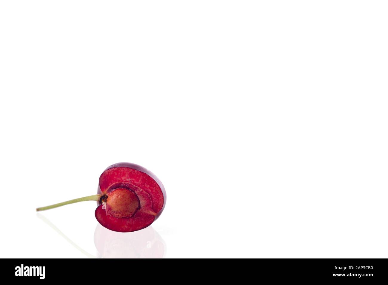 Half cherry with cherry stone isolated on white background with a ...