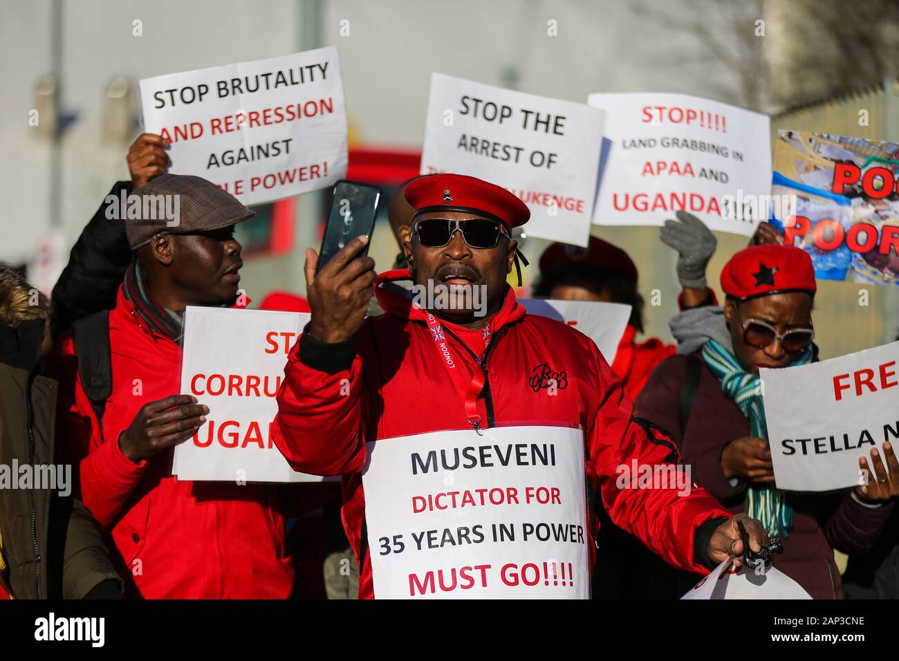 London, UK. 20th Jan, 2020. Ugandan protesters hold placards during a ...