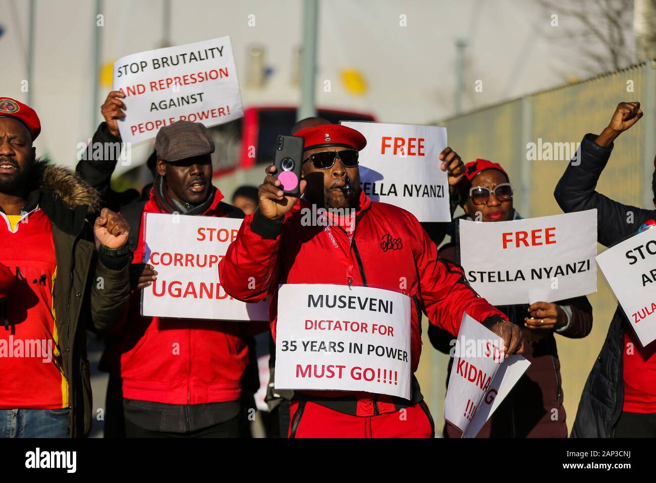 London, UK. 20th Jan, 2020. Ugandan protesters hold placards during a ...