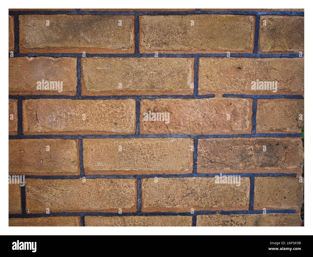 Coarse brick wall with colorful mortar Stock Photo - Alamy