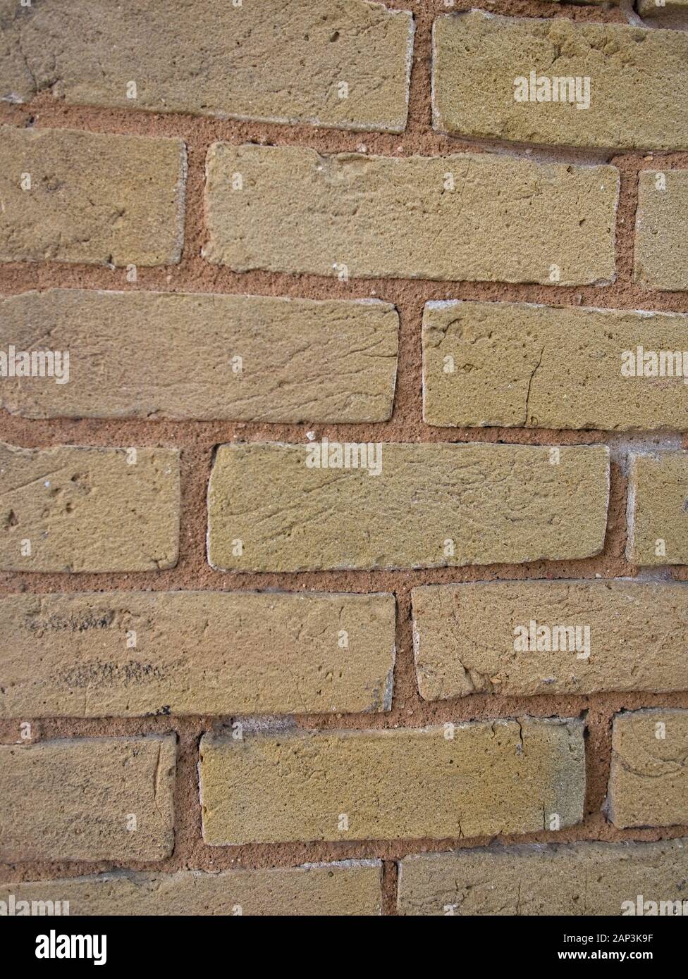Coarse brick wall with colorful mortar Stock Photo - Alamy