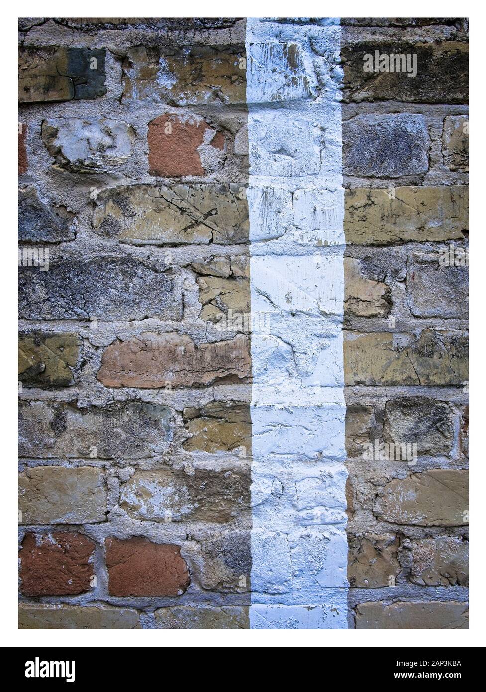 Colorful,coarse brick wall with painted vertical white stripe Stock ...