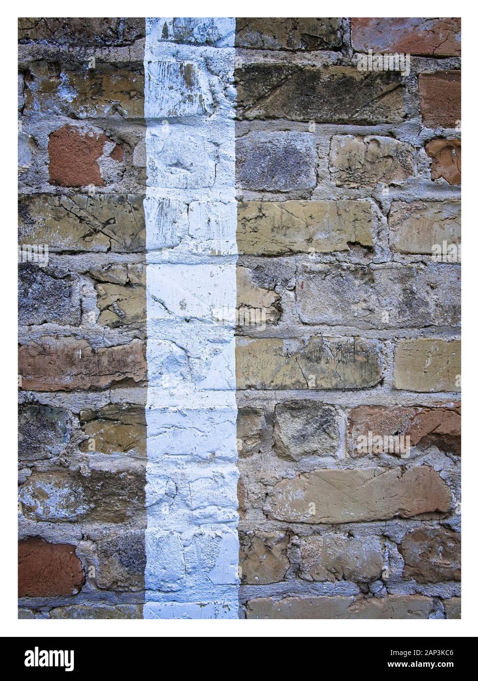 Colorful,coarse brick wall with painted vertical white stripe Stock ...