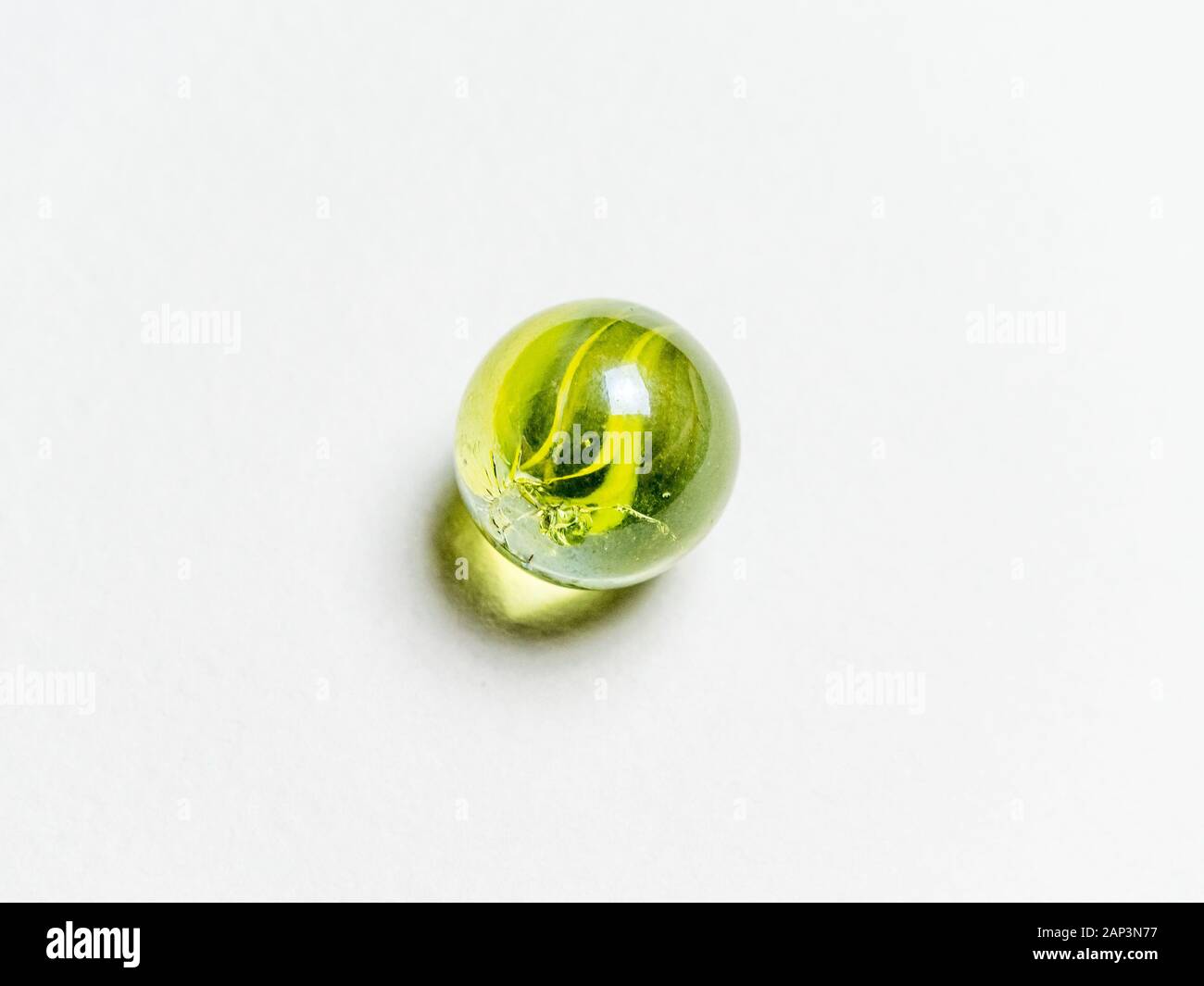 One green glass ball with caustic on white background Stock Photo - Alamy