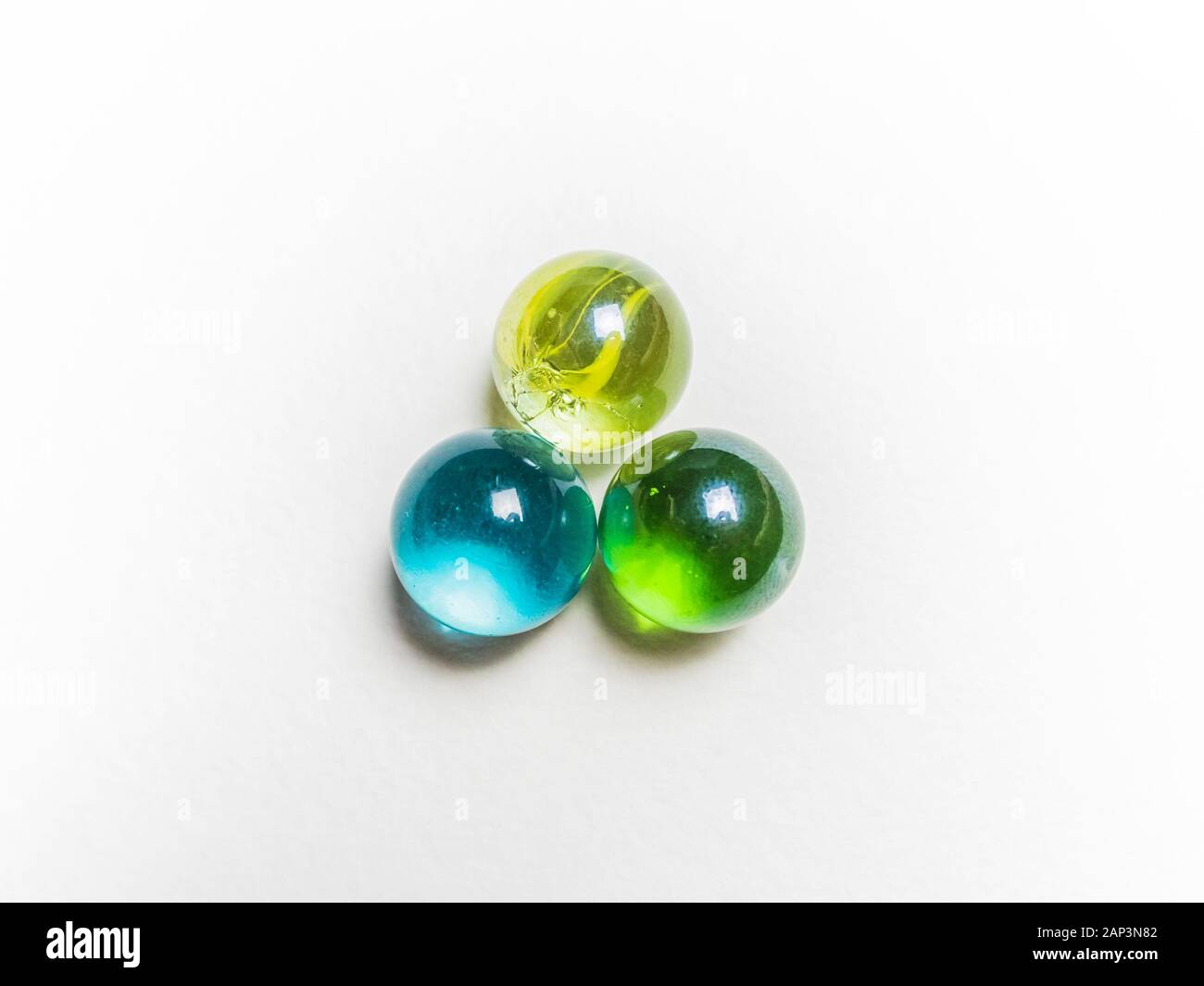 Three colored glass balls with caustics on white background Stock Photo ...