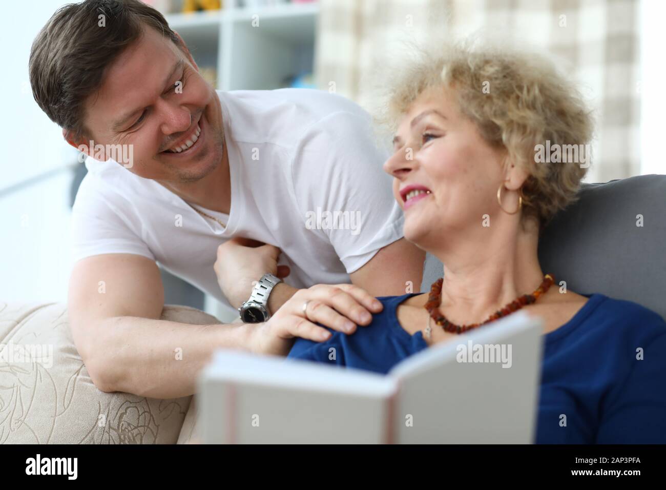 Son speaking with mother Stock Photo - Alamy