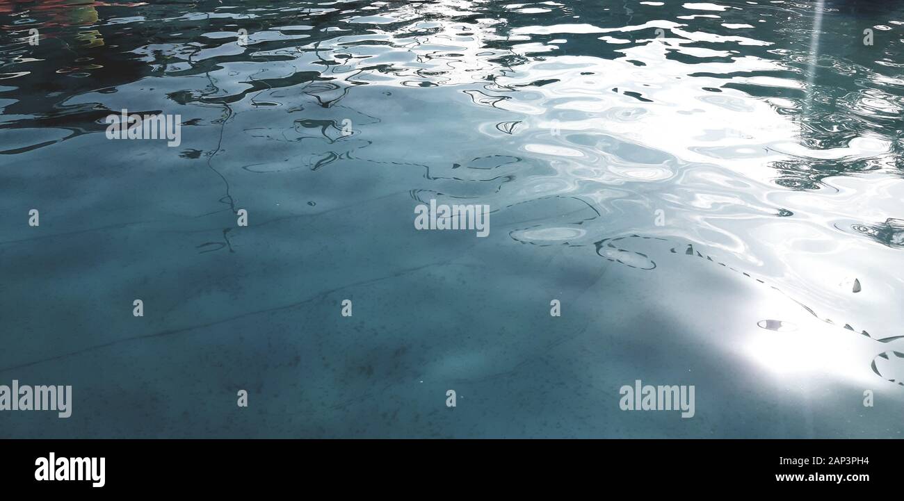 Water in a blue pool with light reflection day Stock Photo - Alamy