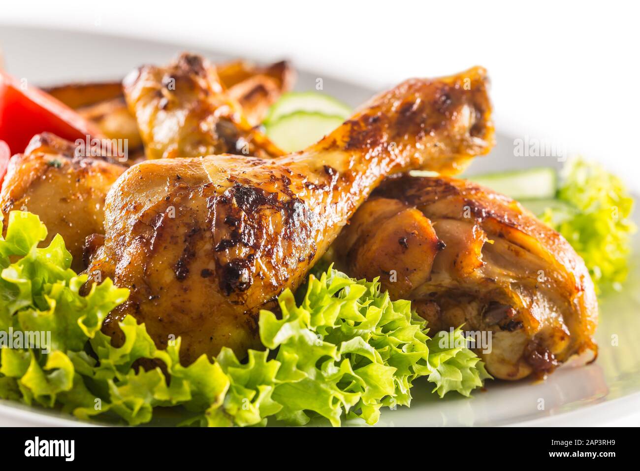 Roasted chicken legs with lettuce salad and tomatoes Stock Photo - Alamy