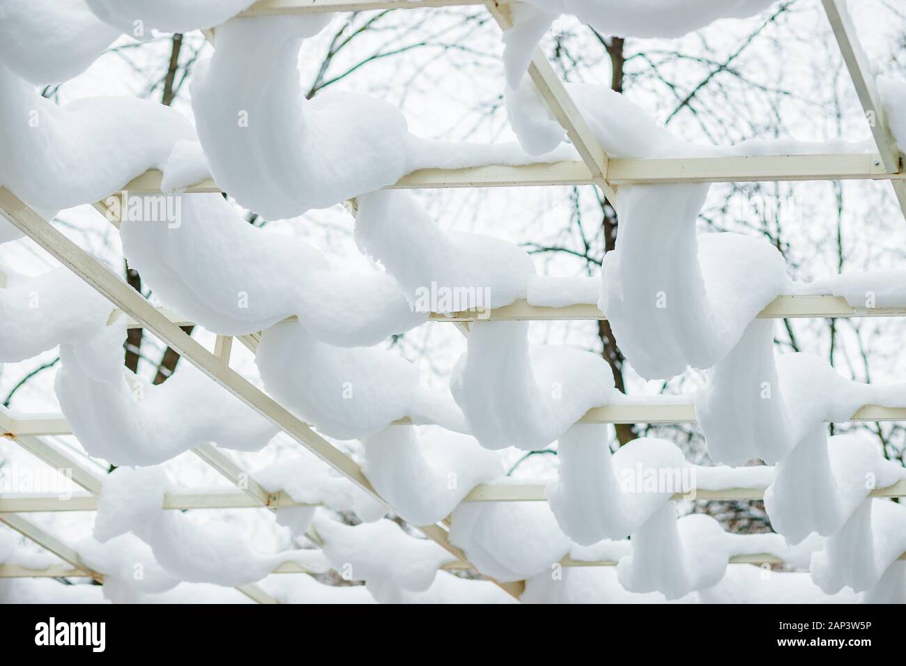Closeup of wooden deck fence railing side, pole, post covered, in piled ...