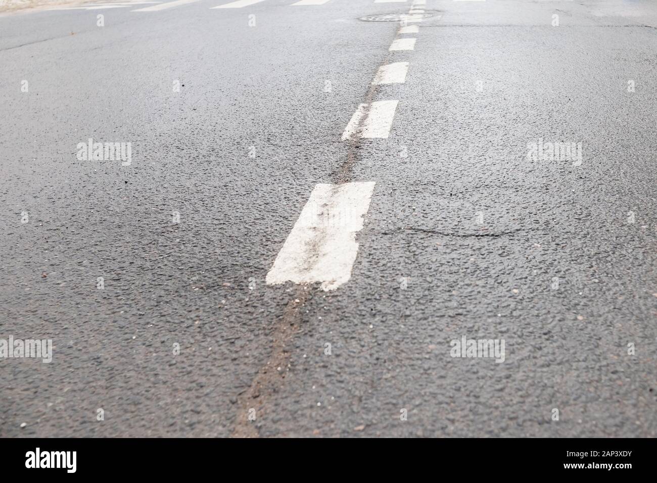 old asphalt texture with white dashed line Stock Photo - Alamy