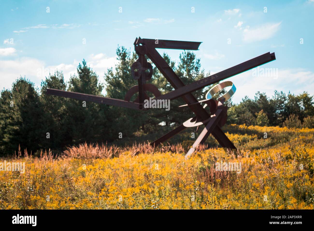Large steel beam statue in a field at the Frederik Meijer Gardens Stock ...