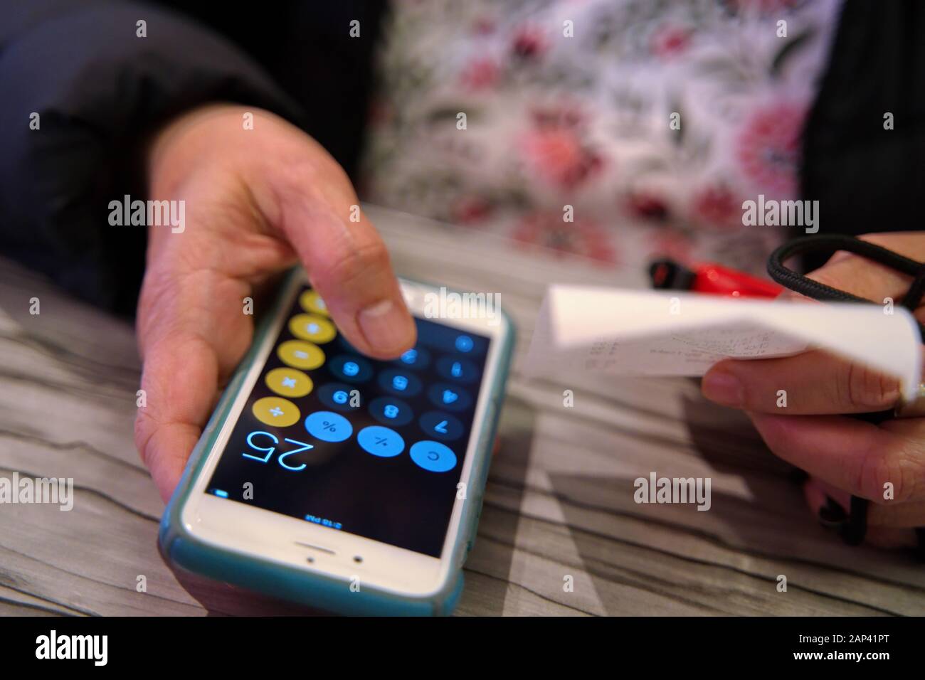 Calculator being used by dining customer to determine waiter`s tip ...