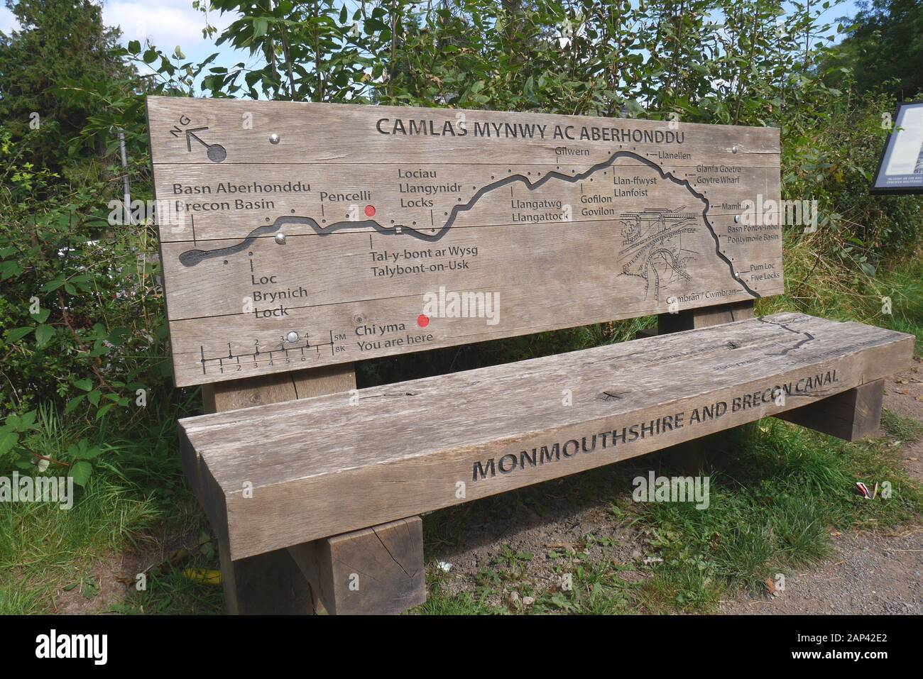 Bench with a map of the canal on the towpath of the Brecon and ...