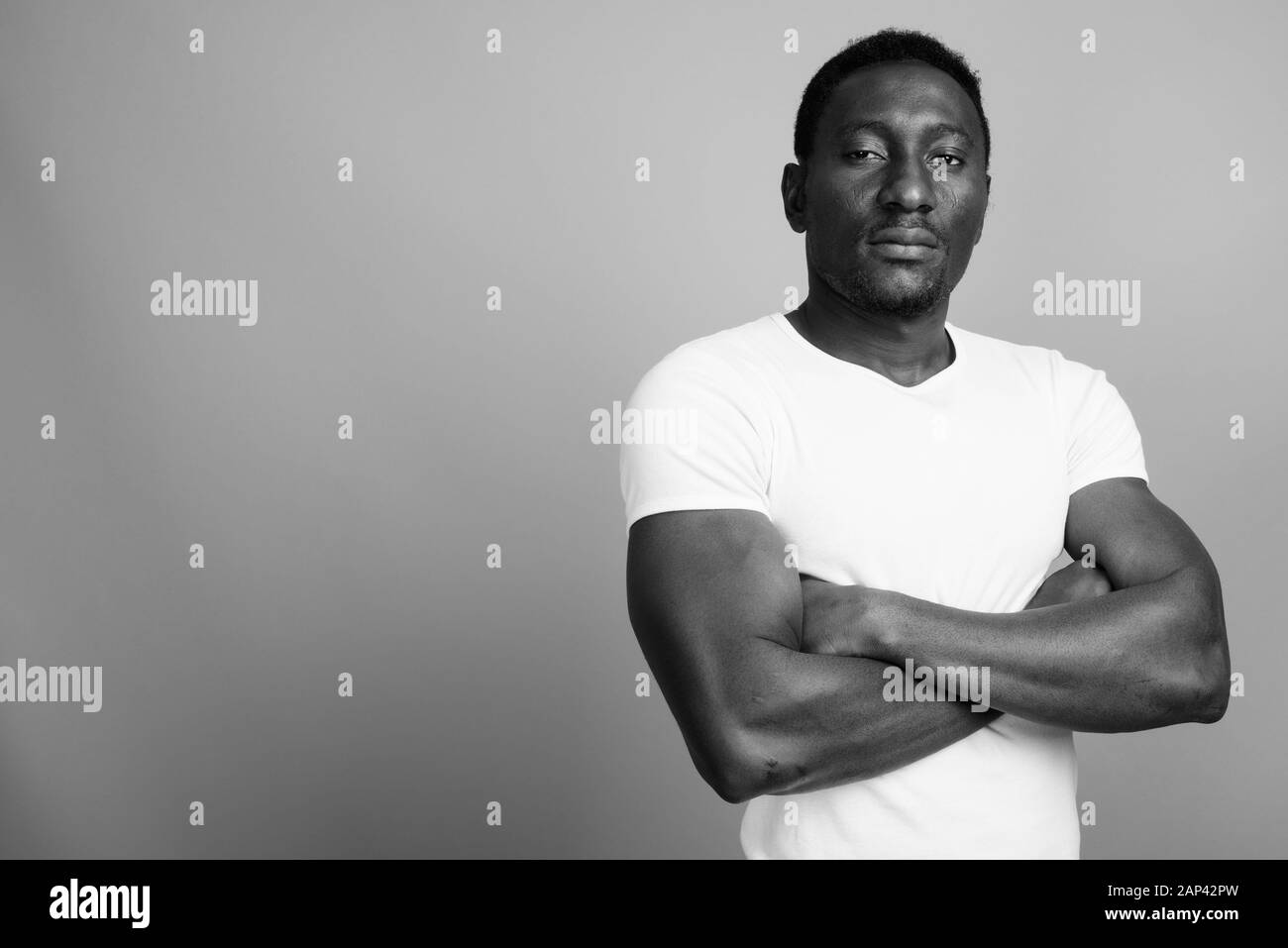 Young handsome African man against gray background Stock Photo - Alamy