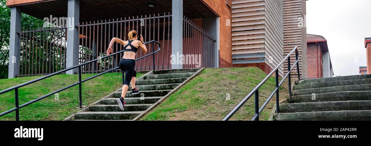 Female athlete climbing stairs outdoors Stock Photo - Alamy