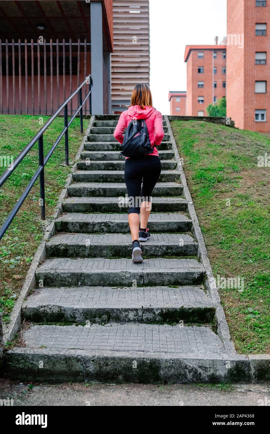 Female athlete going up stairs outdoors Stock Photo - Alamy
