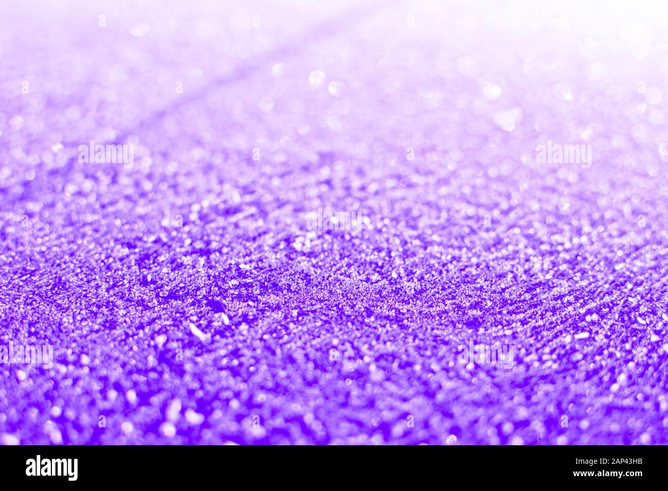 Texture of sparkling first cold ice. Snowy backdrop in purple colors ...