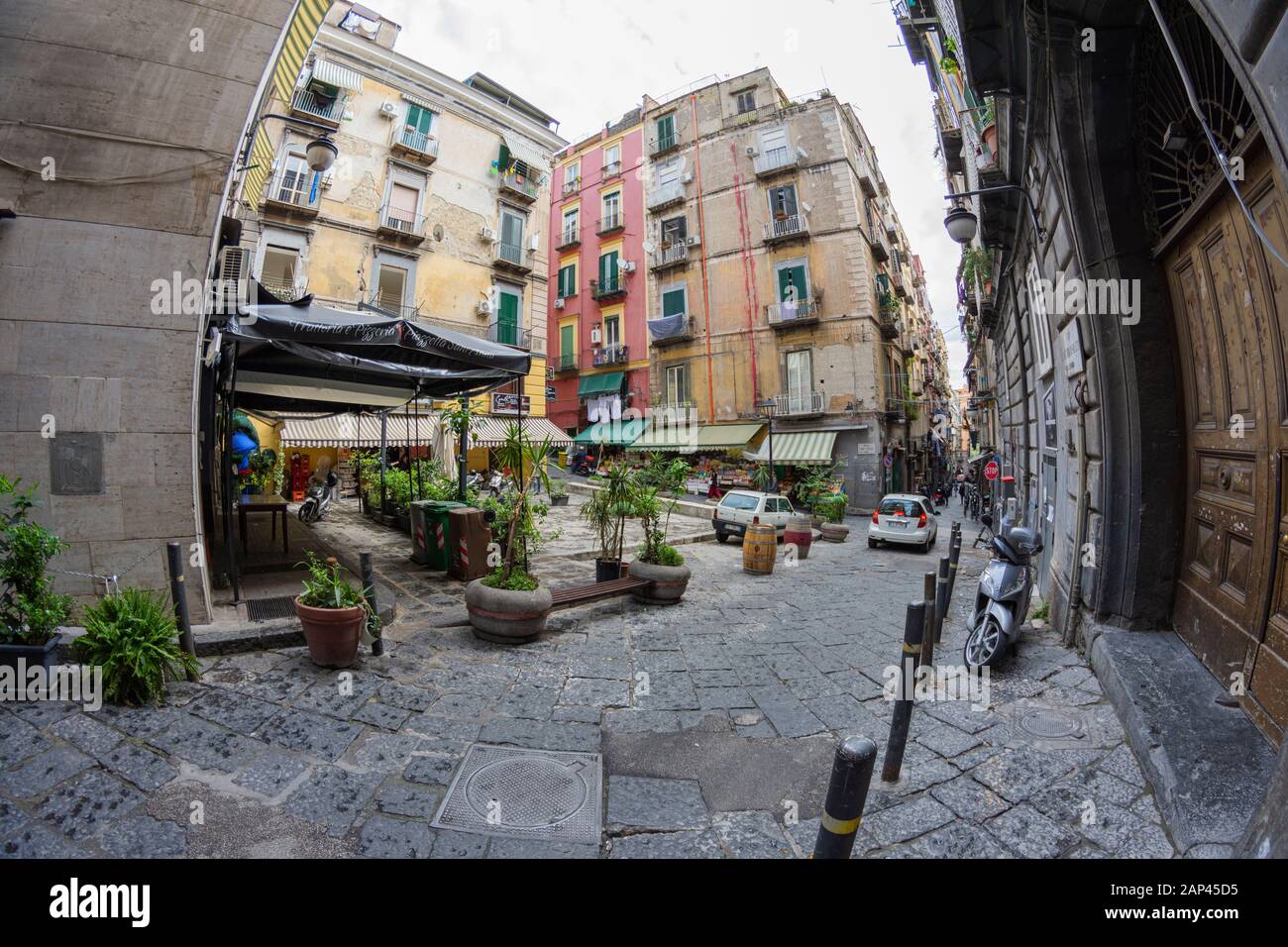 А small square between the narrow streets of downtown Naples with shops ...