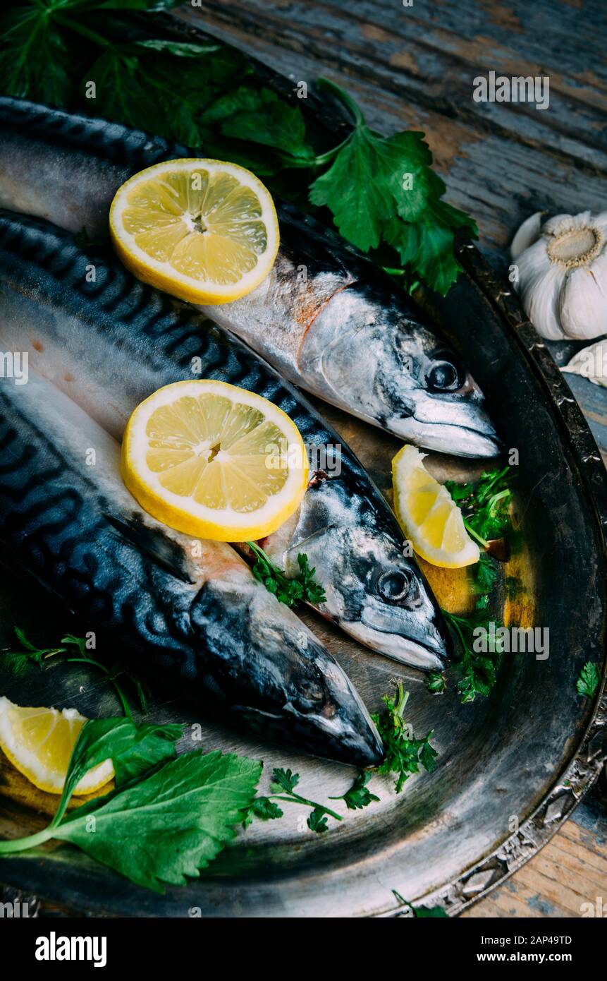 Fresh mackerel fish with lemon and spices served on silver plate from ...