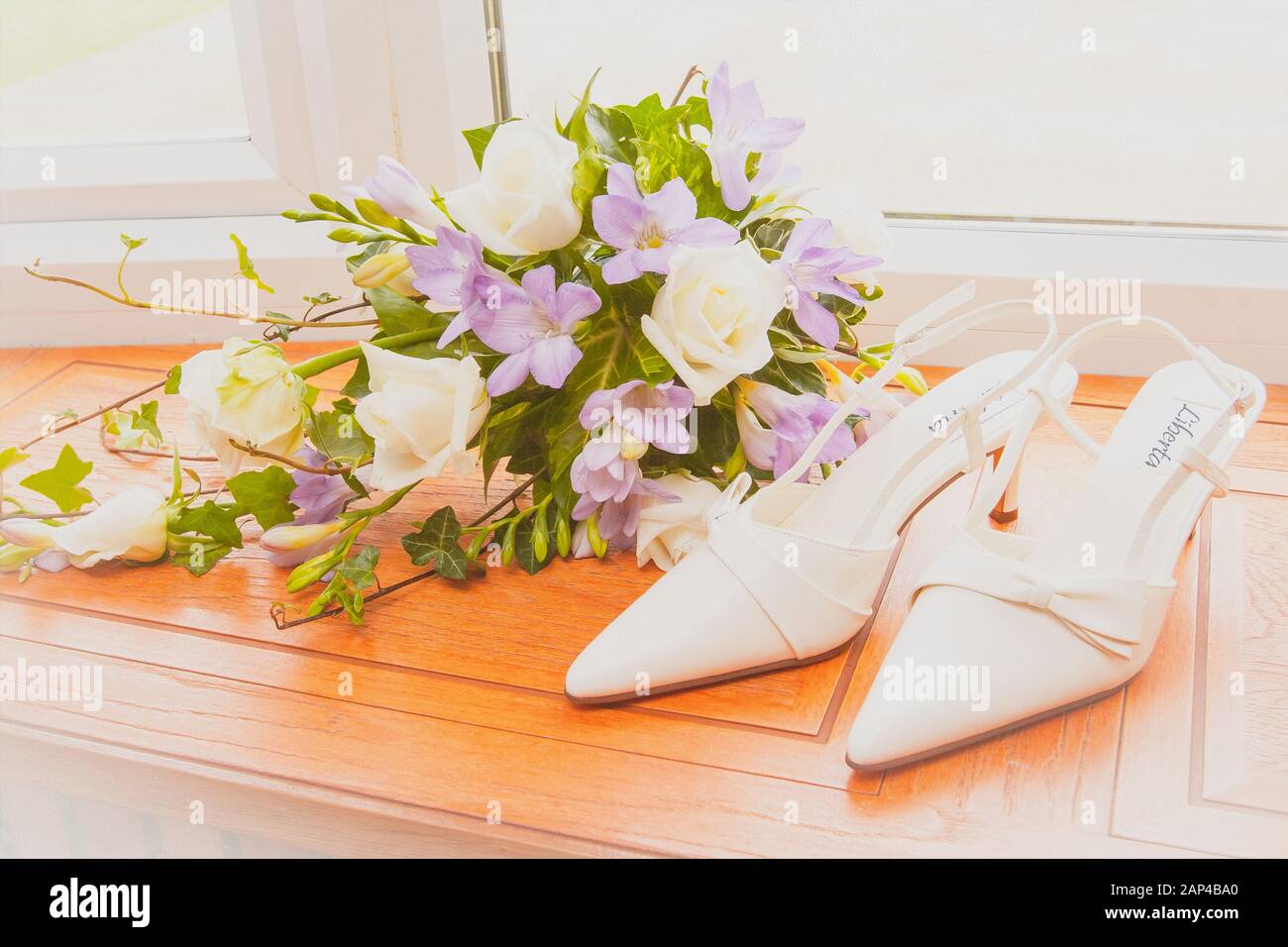 Flower and bride shoe display on the window shelves Stock Photo - Alamy