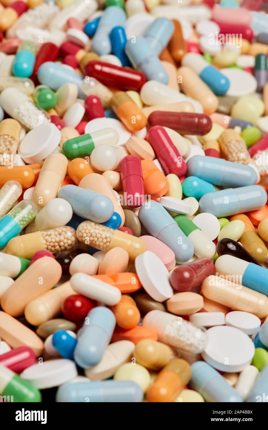 Background with a lot of different colorful medicines drugs and pills ...